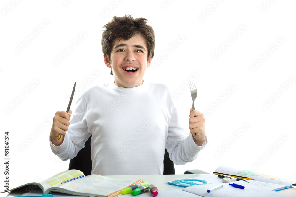 Caucasian smooth-skinned boy doing homework with fork and knife Stock ...