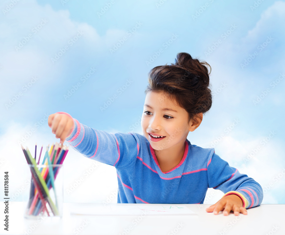 happy little girl drawing with coloring pencils Stock Photo | Adobe Stock