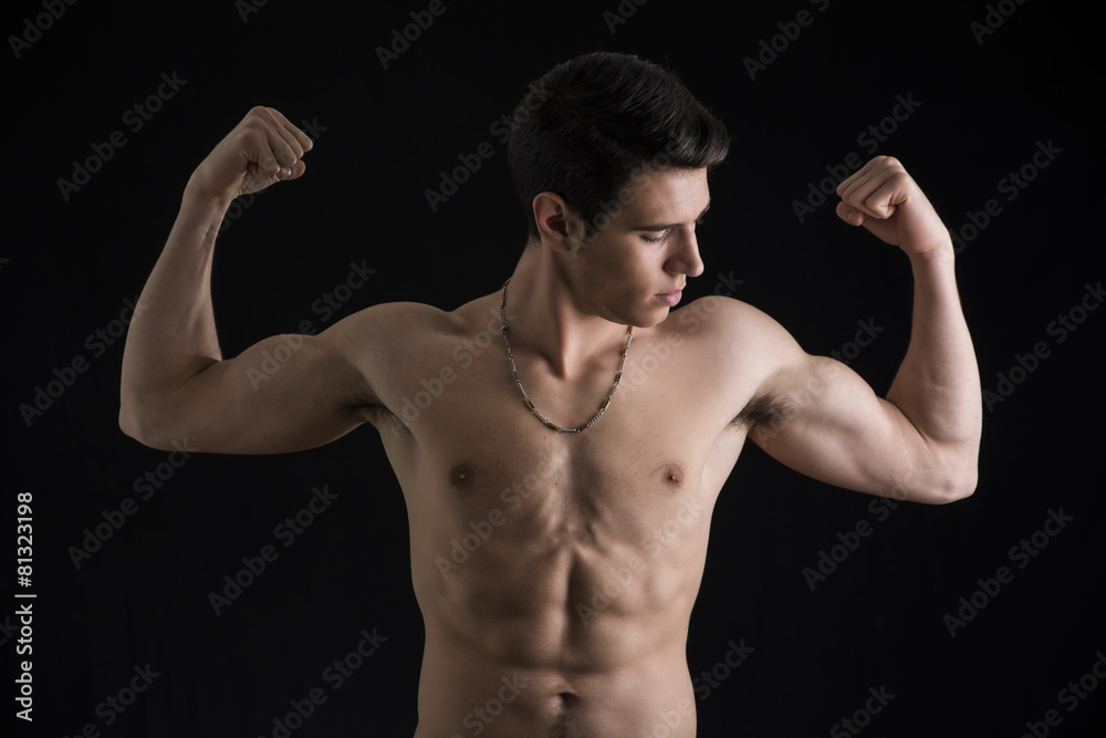 Shirtless muscular young man doing double biceps pose Stock Photo ...