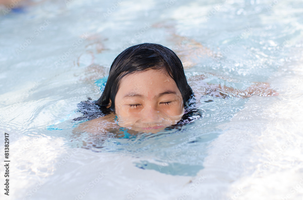 Portrait of Asian girl swimming in swimming pool Stock Photo | Adobe Stock