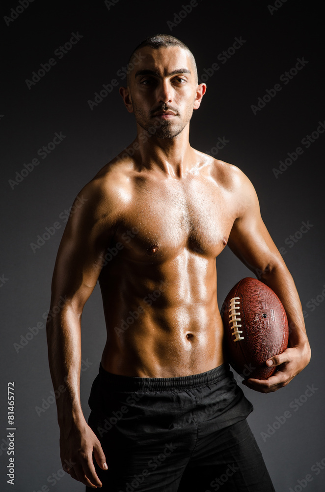 Muscular football player with ball Stock Photo | Adobe Stock