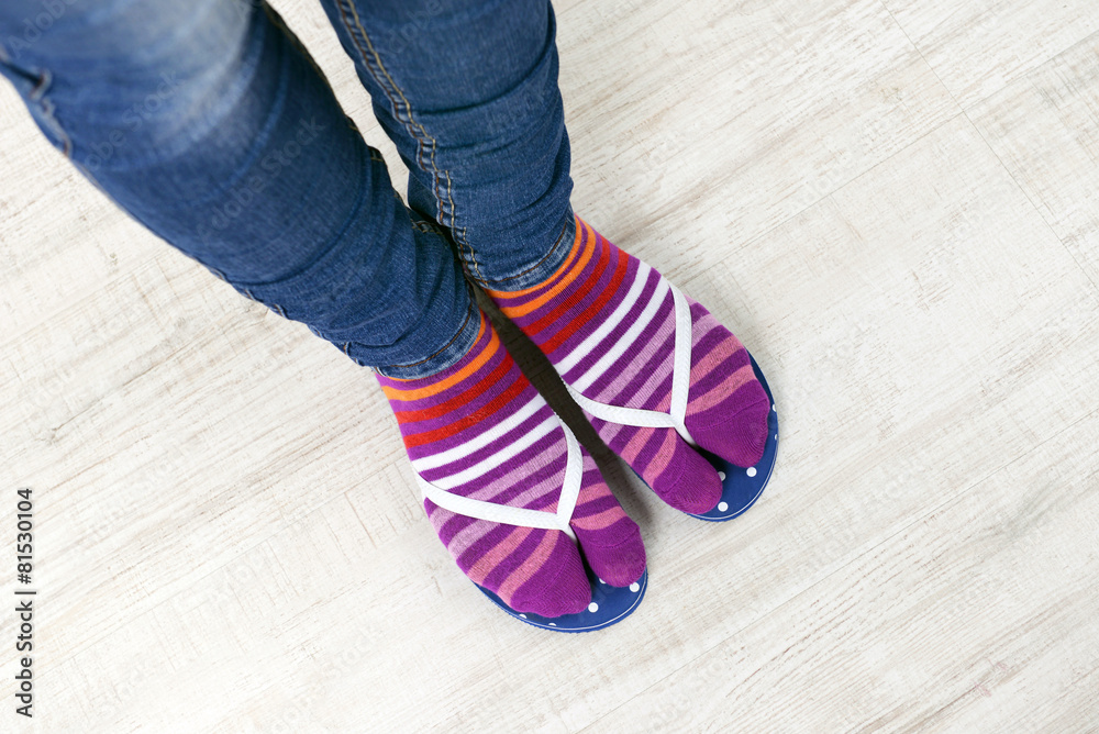 Female feet in socks with pink flip-flops, on floor background Stock ...
