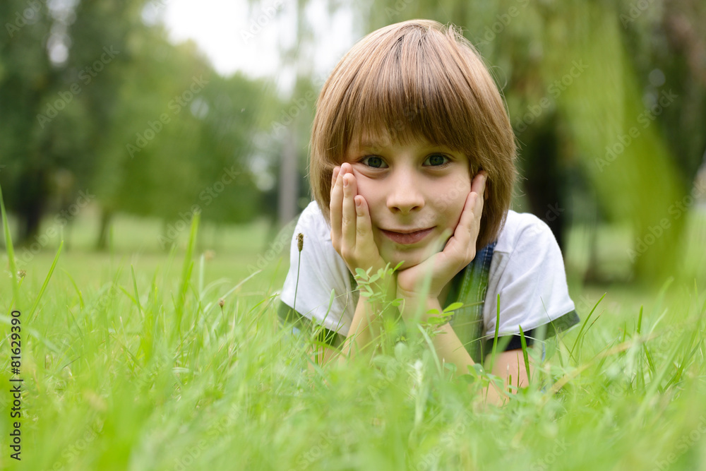 Cute little boy laying in green grass, summer nature outdoor Stock ...