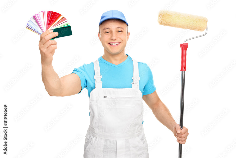Painter holding a paint roller and color guide Stock Photo | Adobe Stock