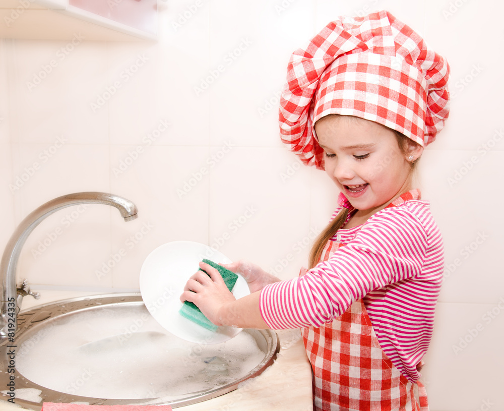 Cute smiling little girl washing the dishes Stock Photo | Adobe Stock
