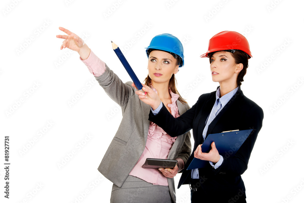 Two engineer woman discussing with eachother. Stock Photo | Adobe Stock