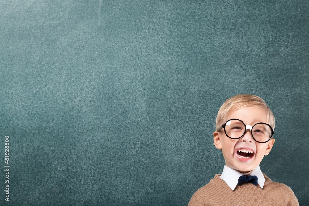 Teacher. Cheerful smiling boy on a green background. Stock Photo | Adobe Stock