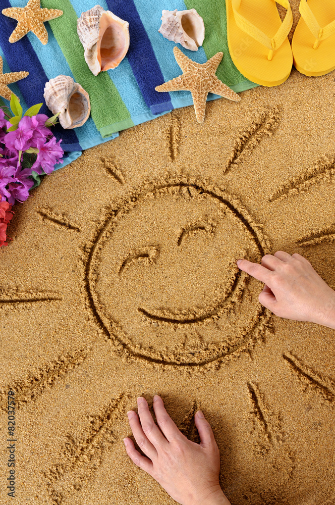 Smiling sun happy smiley face drawing drawn in sand with child hands on ...