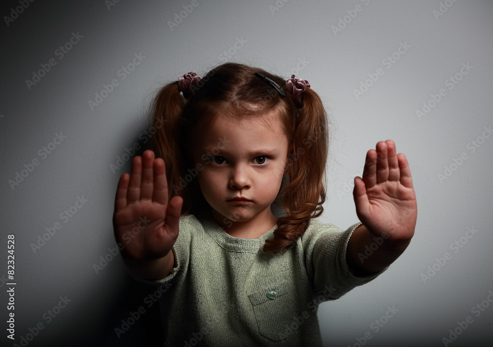 Kid girl showing two hands signaling to stop violence and pain Stock ...