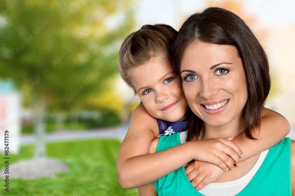 Mother Portrait Of A Daughter Embracing Her Mother From Behind Stock