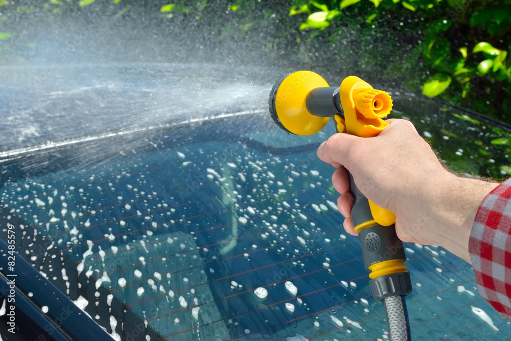 Car Care - Man washing a car using a garden spray gun Stock Photo ...