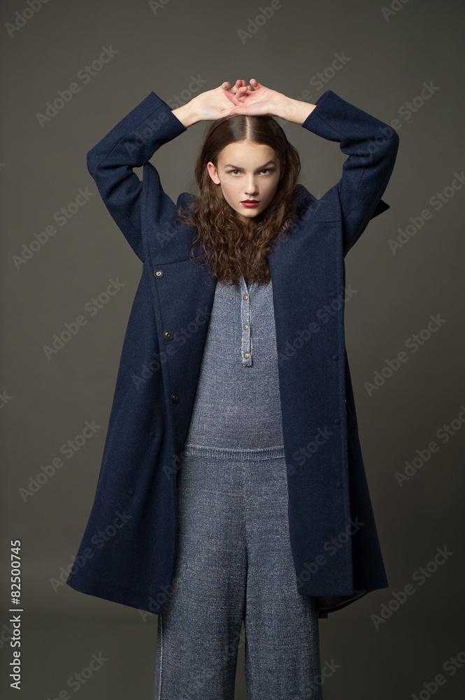 fashion model woman coat and hat urban style pose on color Stock Photo ...