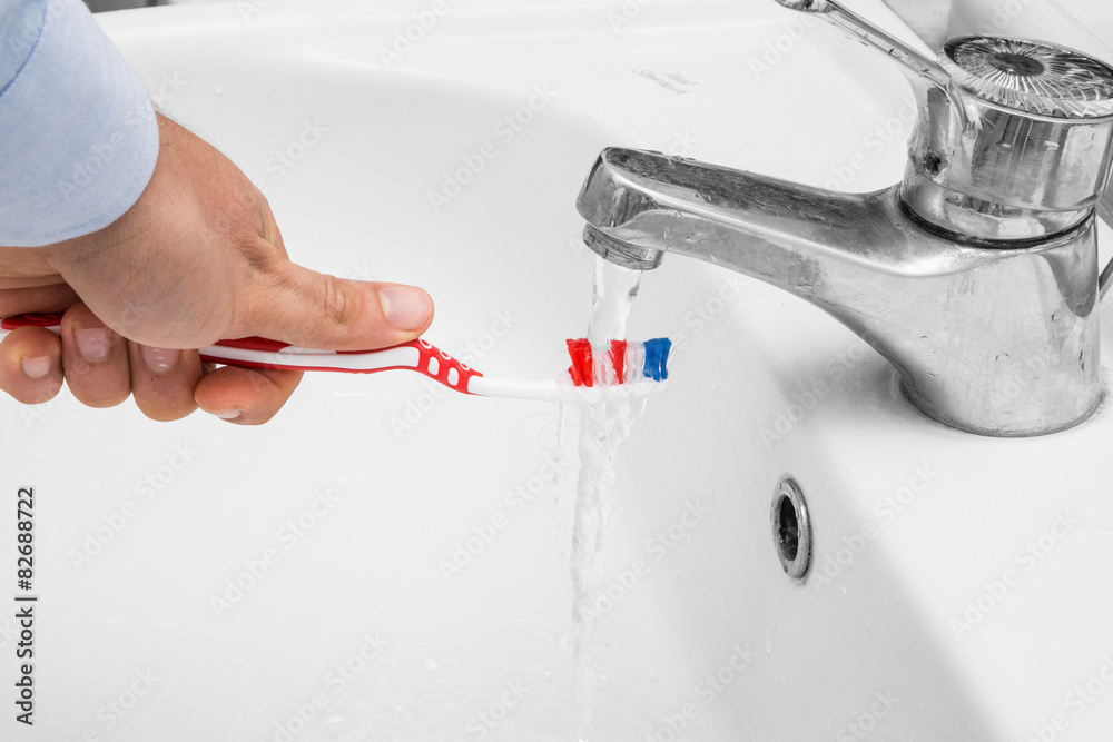 man brushing teeth with toothbrush under the sink water Stock Photo ...