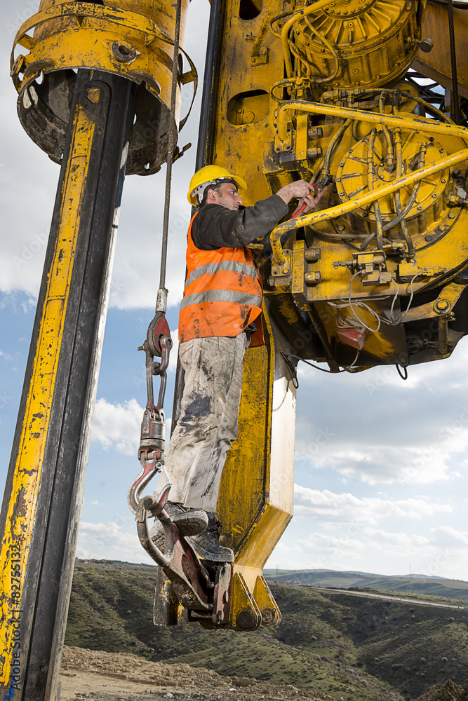 Manual worker fixing drilling pile foundation. Stock Photo | Adobe Stock