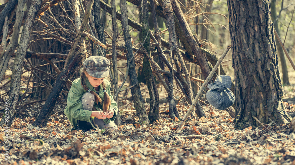 little cute girl making a bonfire in the forest Stock Photo | Adobe Stock
