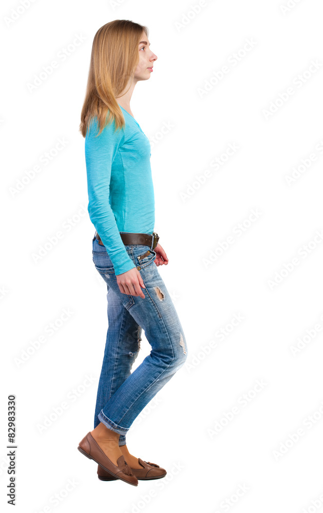 side view of walking woman in jeans. Stock Photo | Adobe Stock