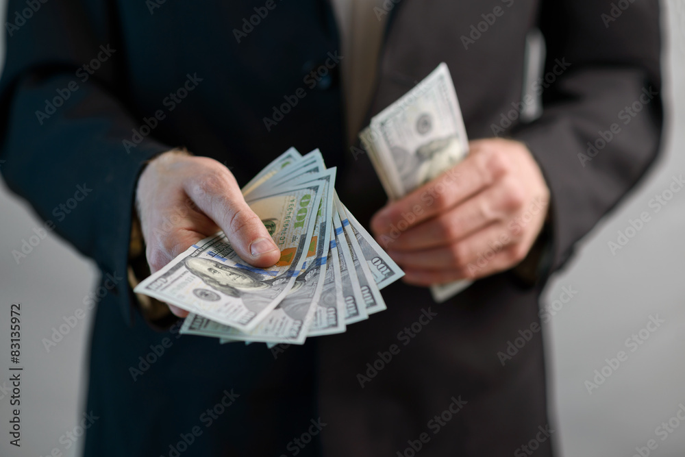 man counts money and gives Stock Photo | Adobe Stock