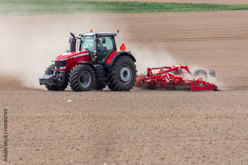 Tractor harrowing the field Stock Photo | Adobe Stock