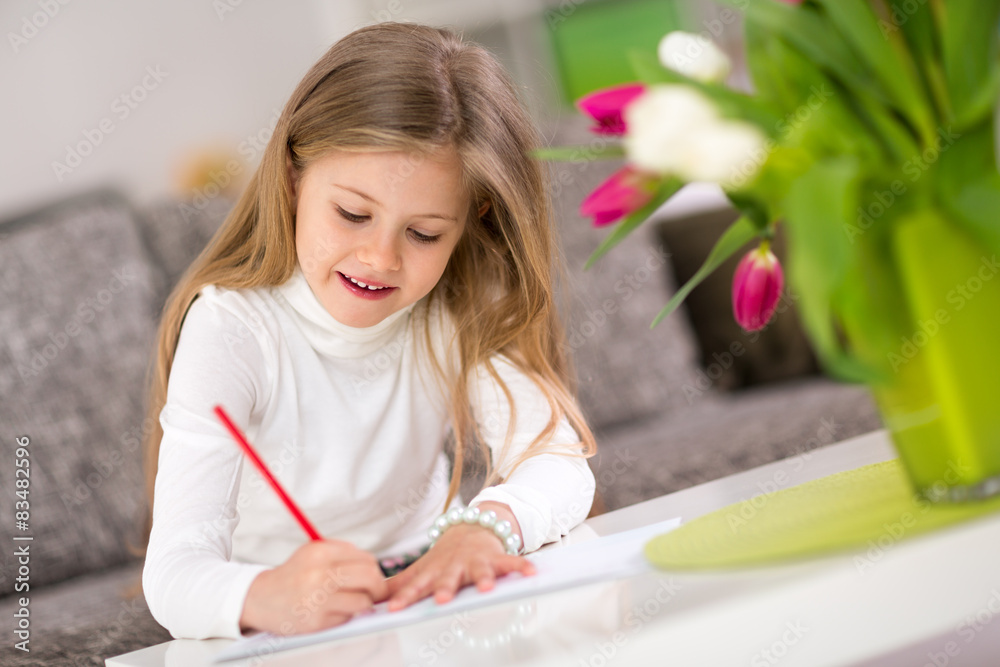 Happy little girl writing Stock Photo | Adobe Stock