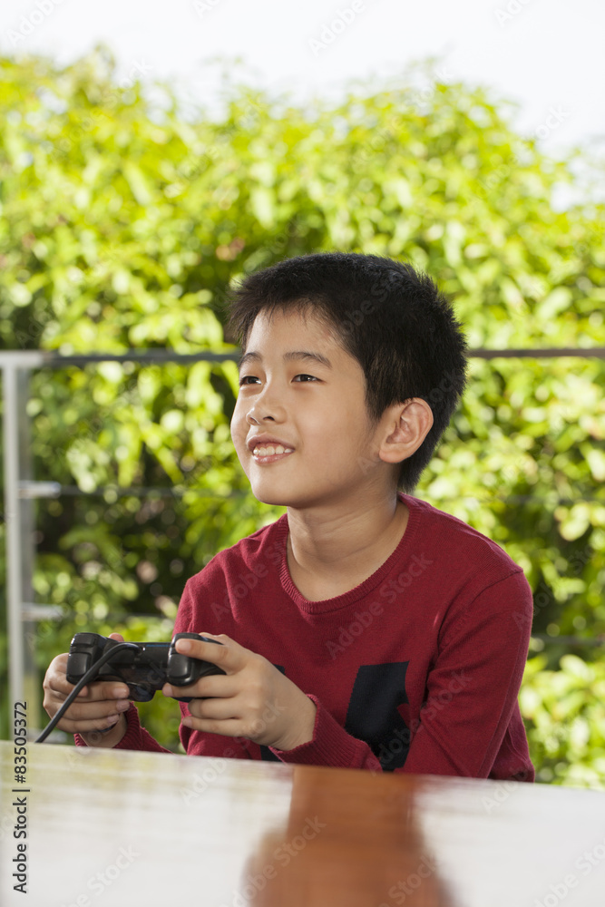 kid life, an Asian boy activity playing game with joystick Stock Photo ...