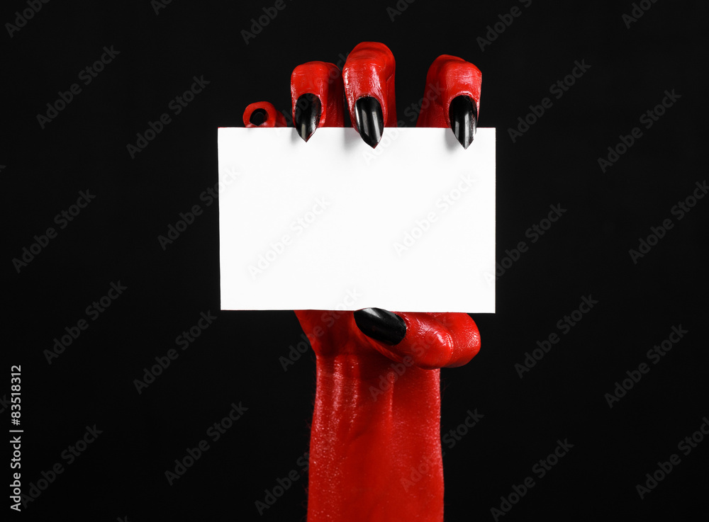 Red devil hand with black nails holding a blank white card Stock Photo ...