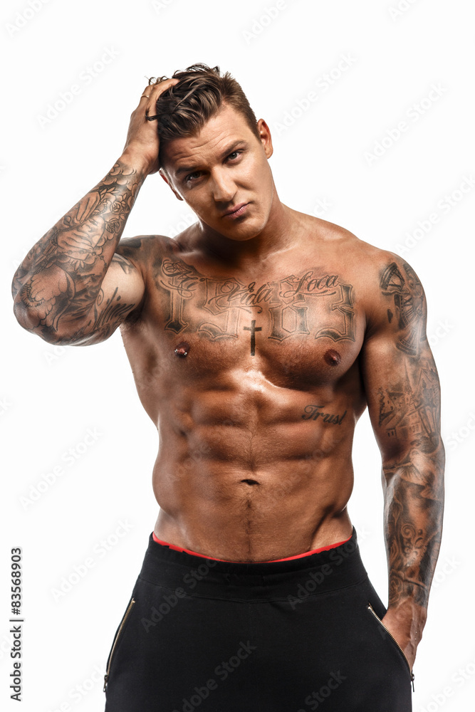 Muscular macho man posing in studio Stock Photo | Adobe Stock