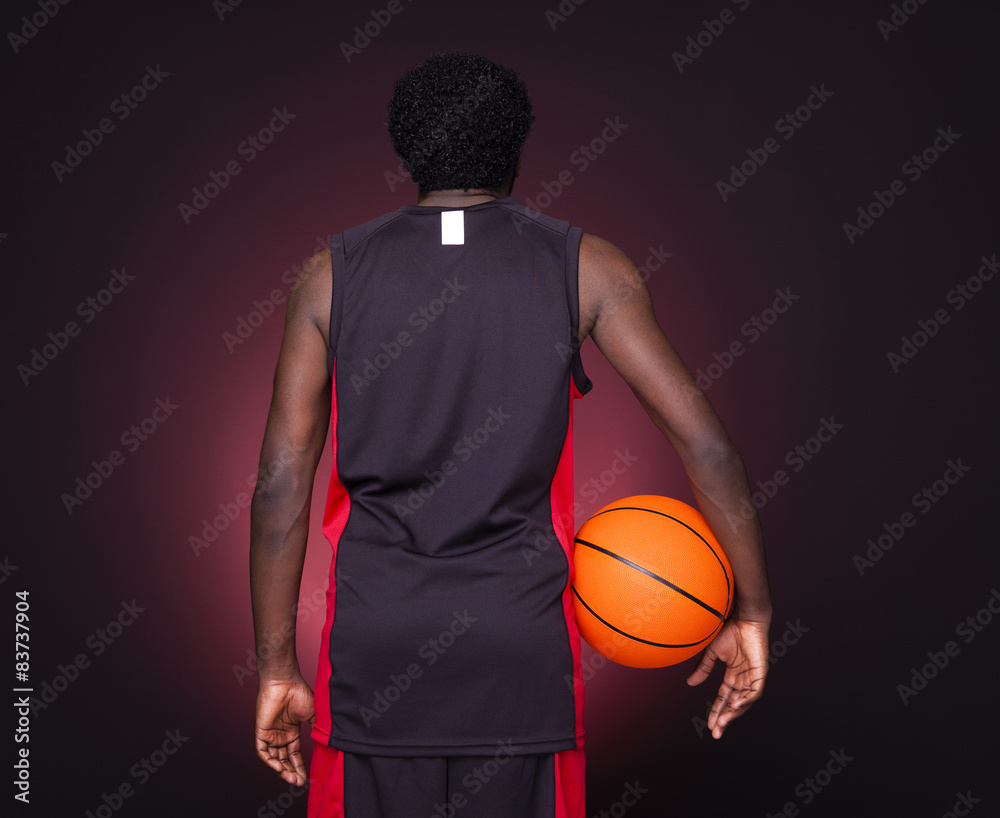 Back view of a basketball player holding a basketball against da Stock ...