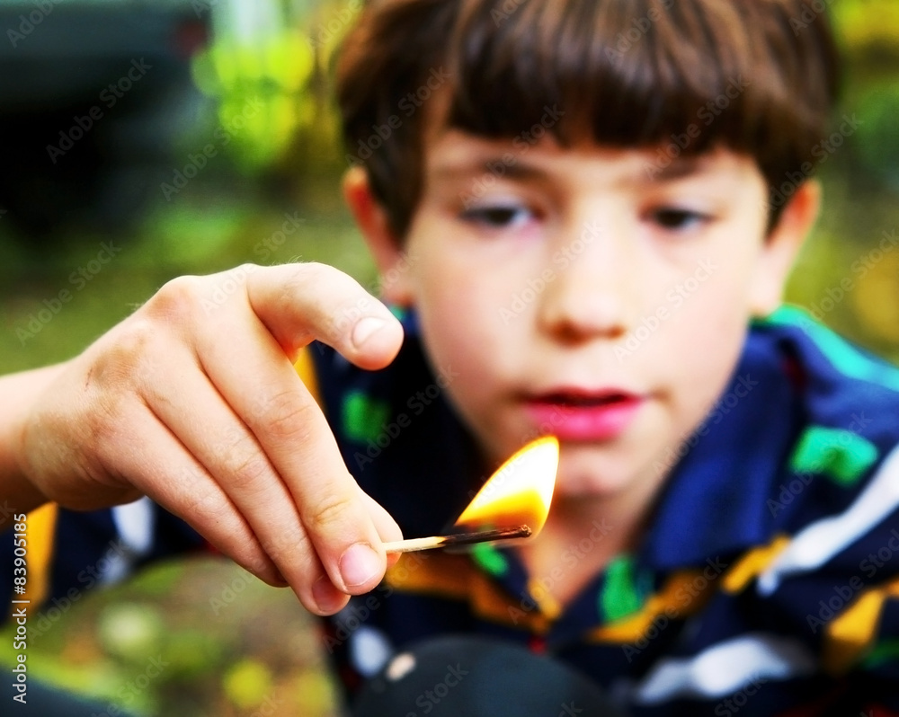 preteen handsome boy play with fire hold match Stock Photo | Adobe Stock