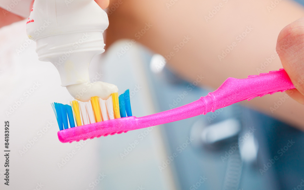 Putting Toothpaste On Toothbrush