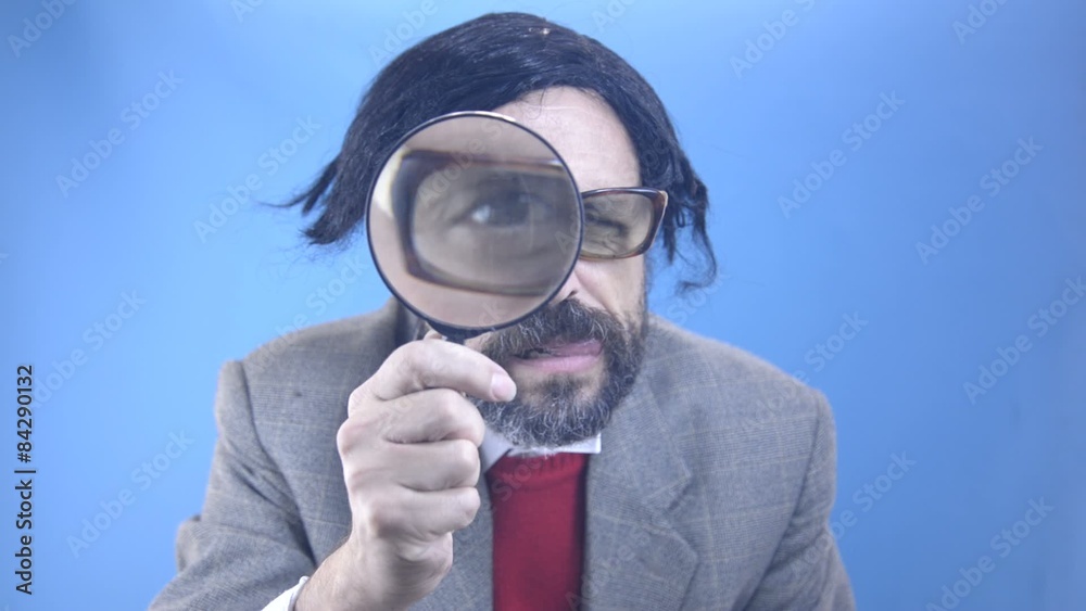 An untidy bizarre man, approaching and looking through a loupe Stock ...
