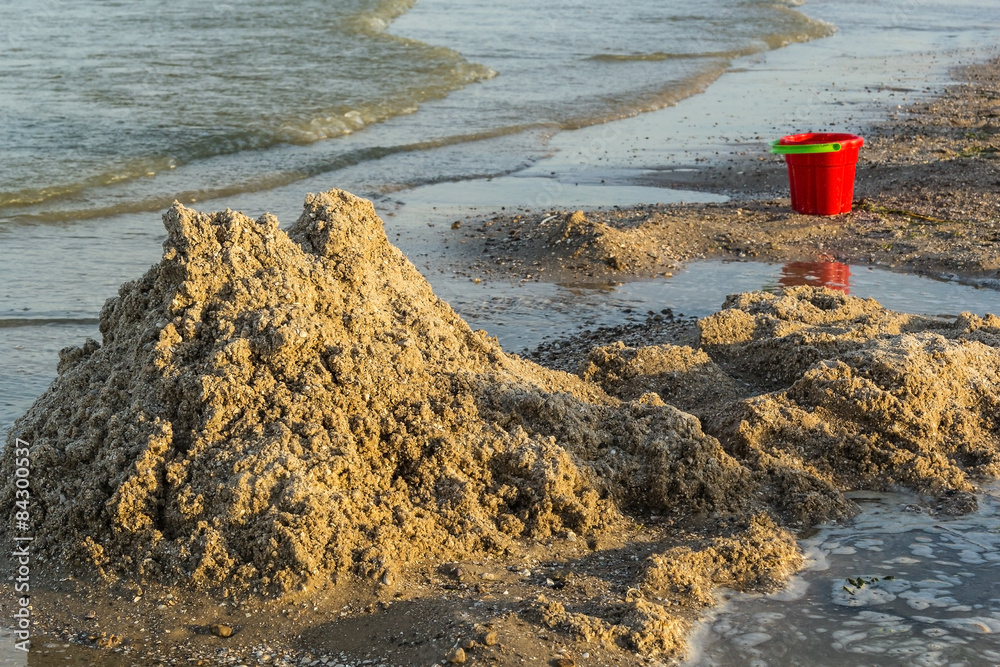 Ruined sand castle and children's bucket Stock Photo | Adobe Stock