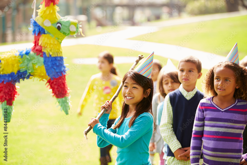 Children Hitting Pinata At Birthday Party Stock Photo | Adobe Stock
