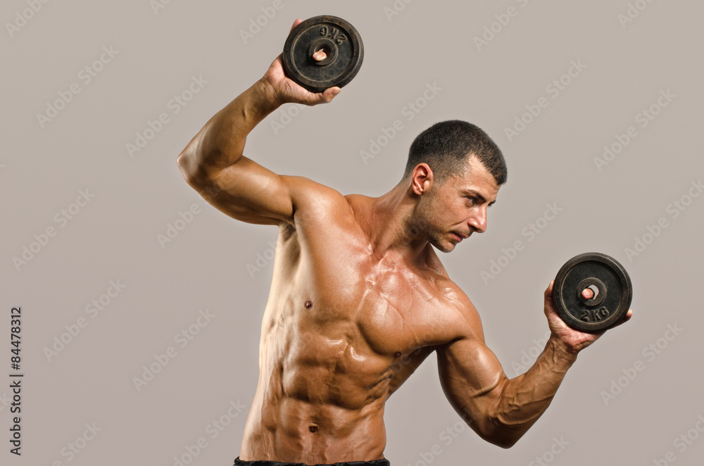 Strong bodybuilder man with perfect abs, shoulders,biceps, triceps and ...