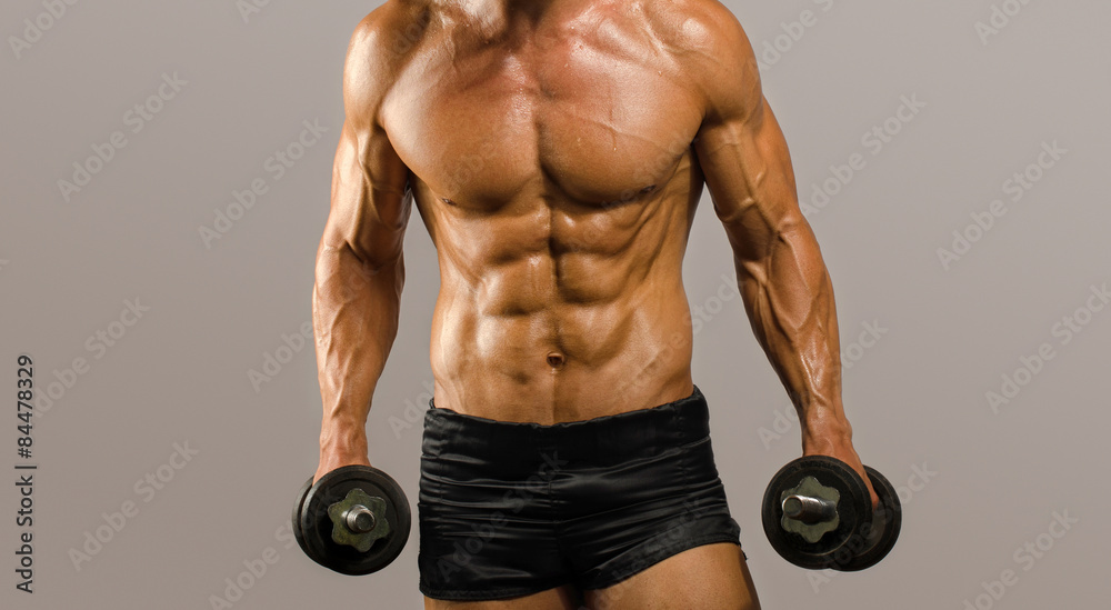 Strong bodybuilder man with perfect abs, shoulders,biceps, triceps and ...