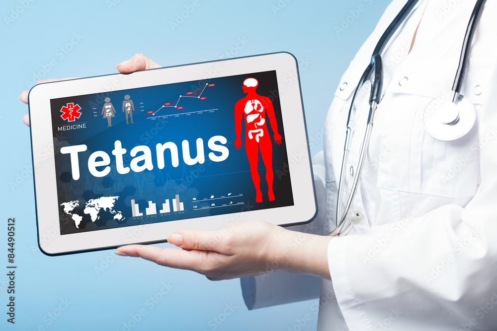 Girl holding Tablet with the diagnosis Tetanus on the display. T Stock ...