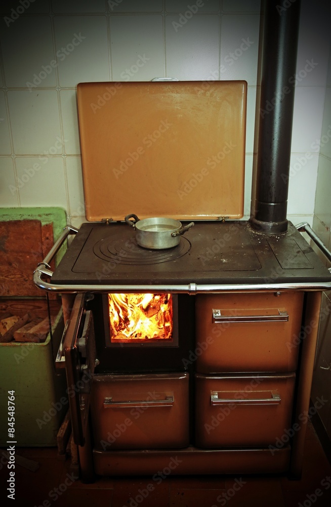 stove a wood-burning Stove with fire lit in the old mountain hom Stock ...