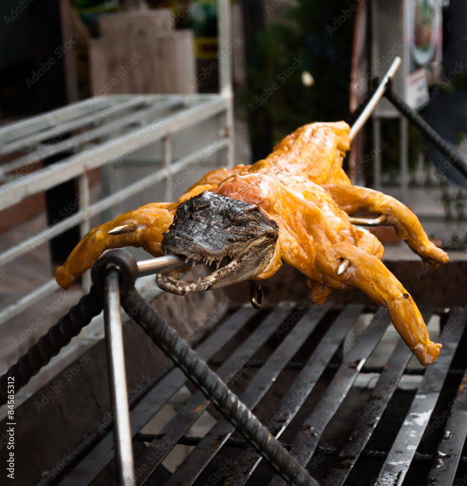 Exotic asian street food - crocodile on grill with skinned skin ...
