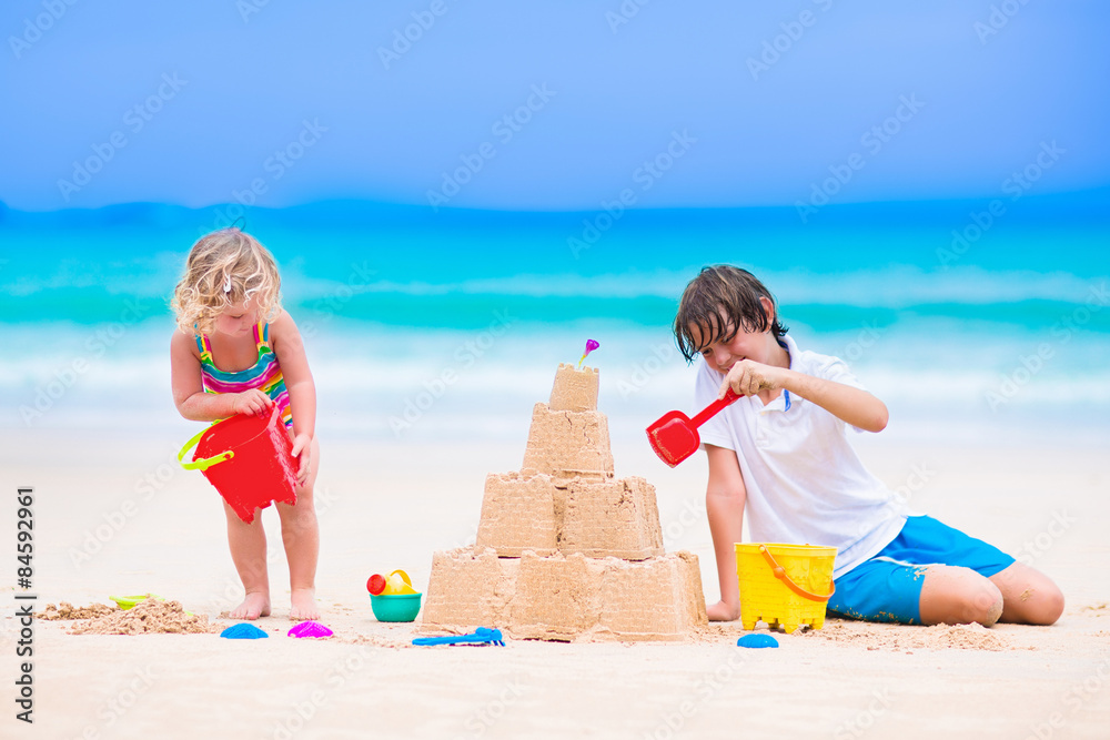 Kids building sand castle on a beach Stock Photo | Adobe Stock
