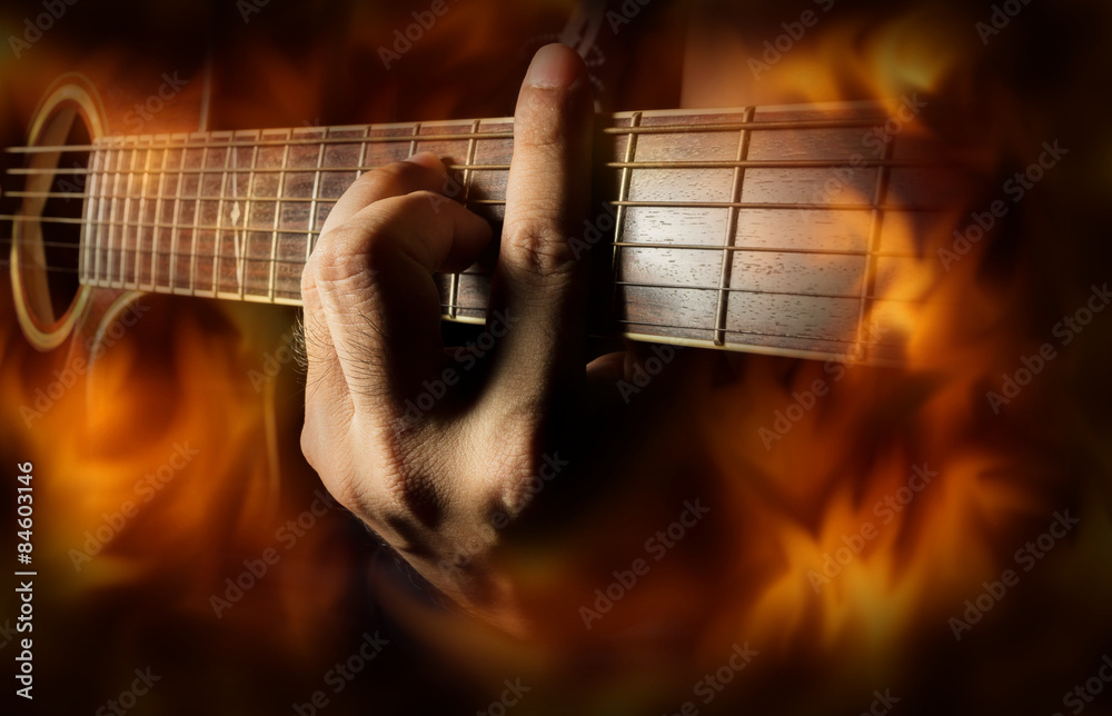 Playing acoustic guitar with fire flame screen. Stock Photo | Adobe Stock