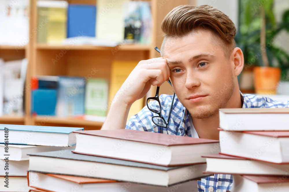 Young student working in a library Stock Photo | Adobe Stock