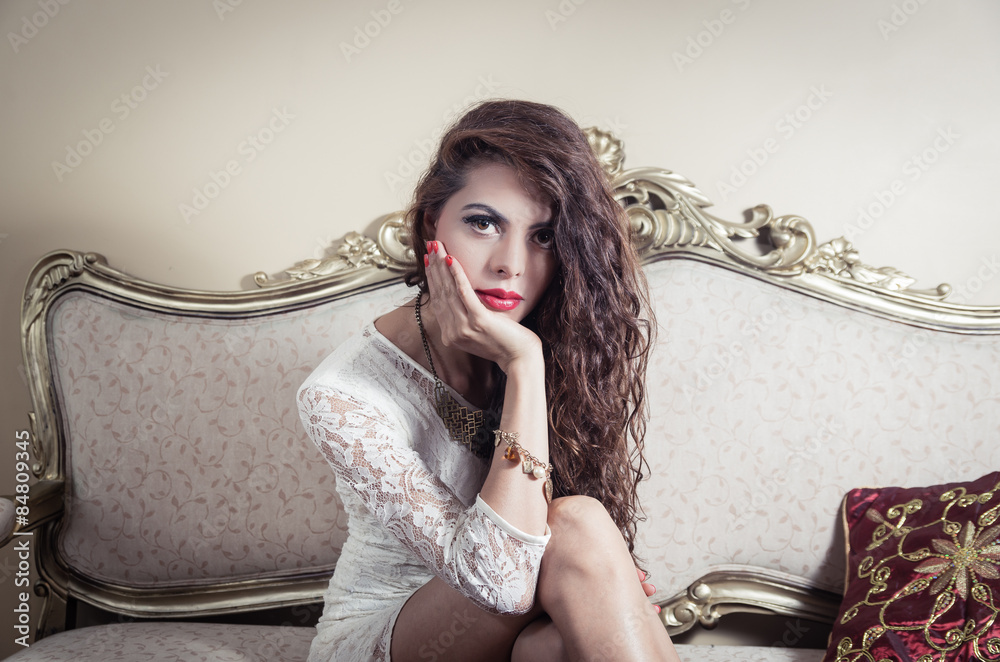Pretty model girl sitting on victorian sofa posing for camera Stock ...