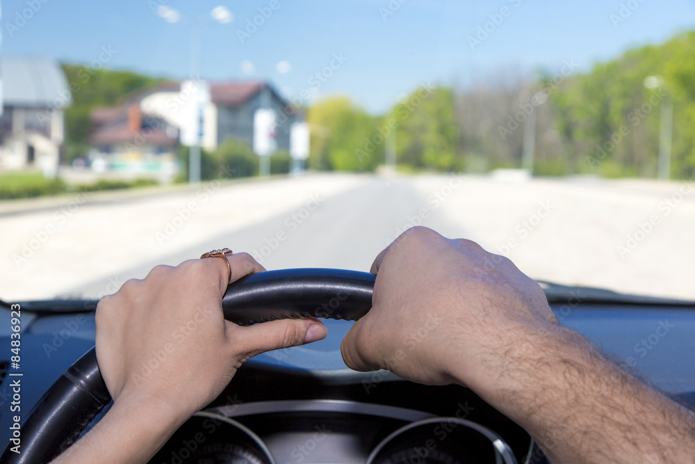 Driving car together. Male and female hands keeping steering wheel car ...