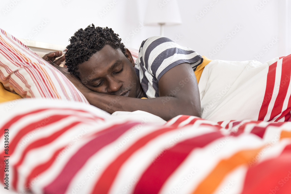 Peaceful african black man sleeping in bed Stock Photo | Adobe Stock