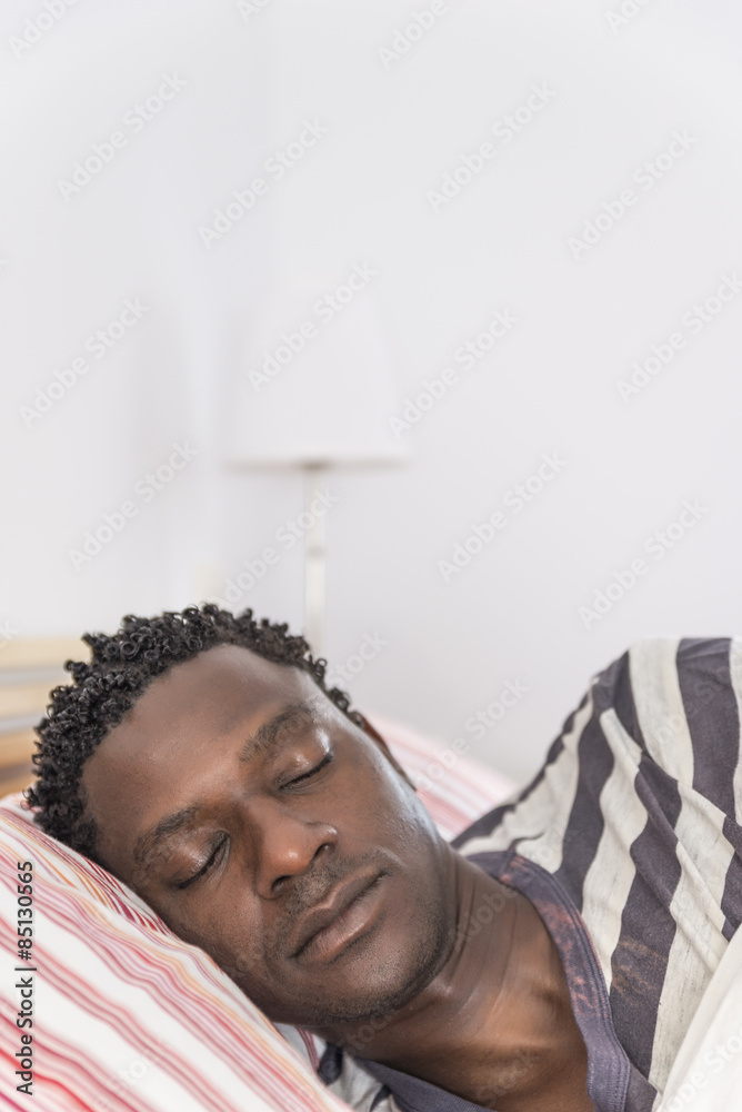 Peaceful african black man sleeping in bed Stock Photo | Adobe Stock