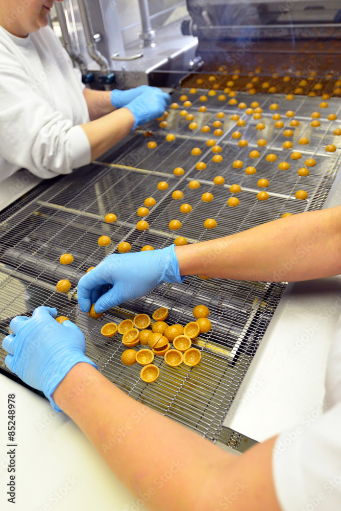 Sorting by hand on the assembly line of a chocolate factory Stock Photo ...