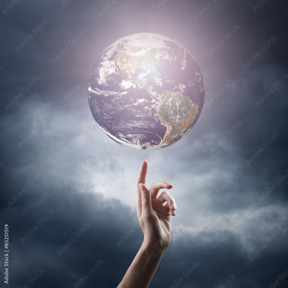 hand pointing at planet in space. Elements of this image are furnished ...