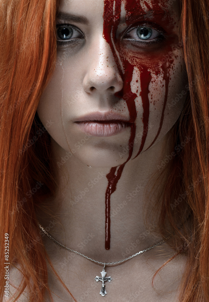 Girl with red hair, bloody face, a chain with a cross, blue eyes ...