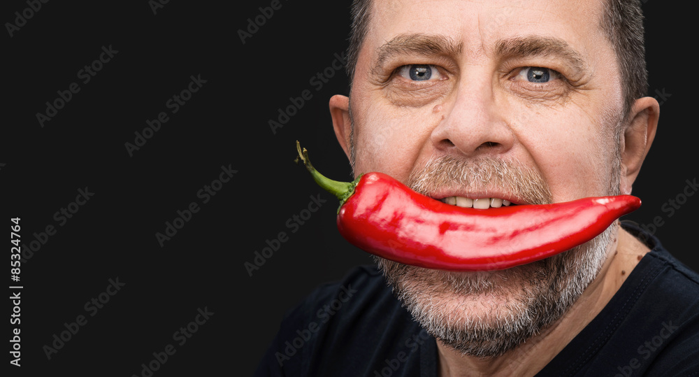 elderly man with red pepper in his mouth Stock-Foto | Adobe Stock