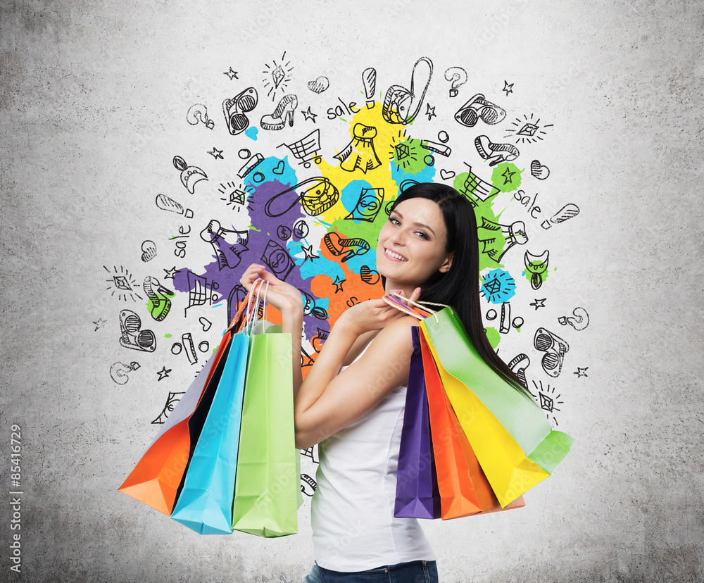 Beautiful smiling young woman with the colourful shopping bags from the ...