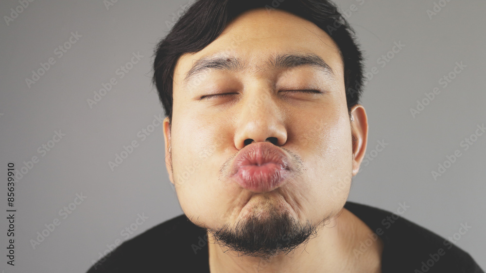 Close up funny kissing face. Photos | Adobe Stock